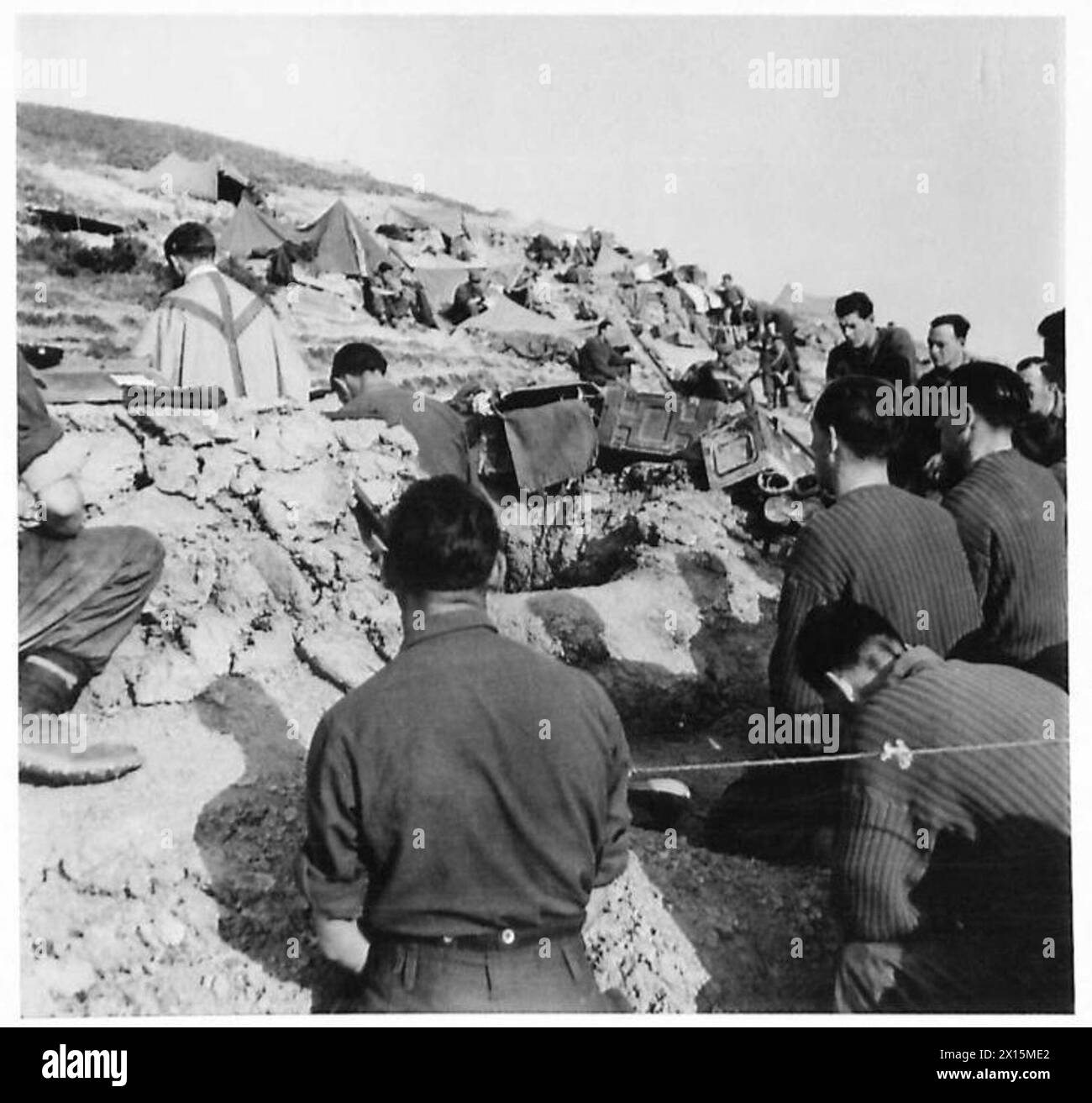 Father Flynn conducts a Roman Catholic service at forward hilltop ...