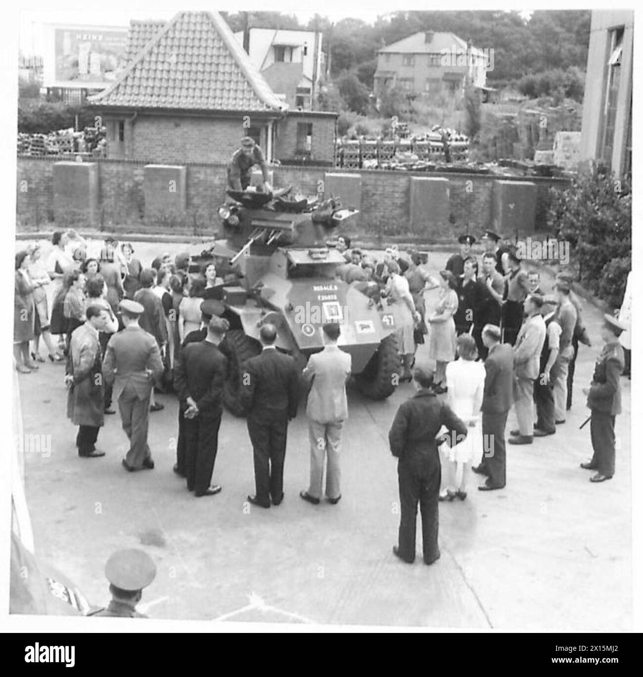 Factory workers inspect an armoured car on the factory grounds ...