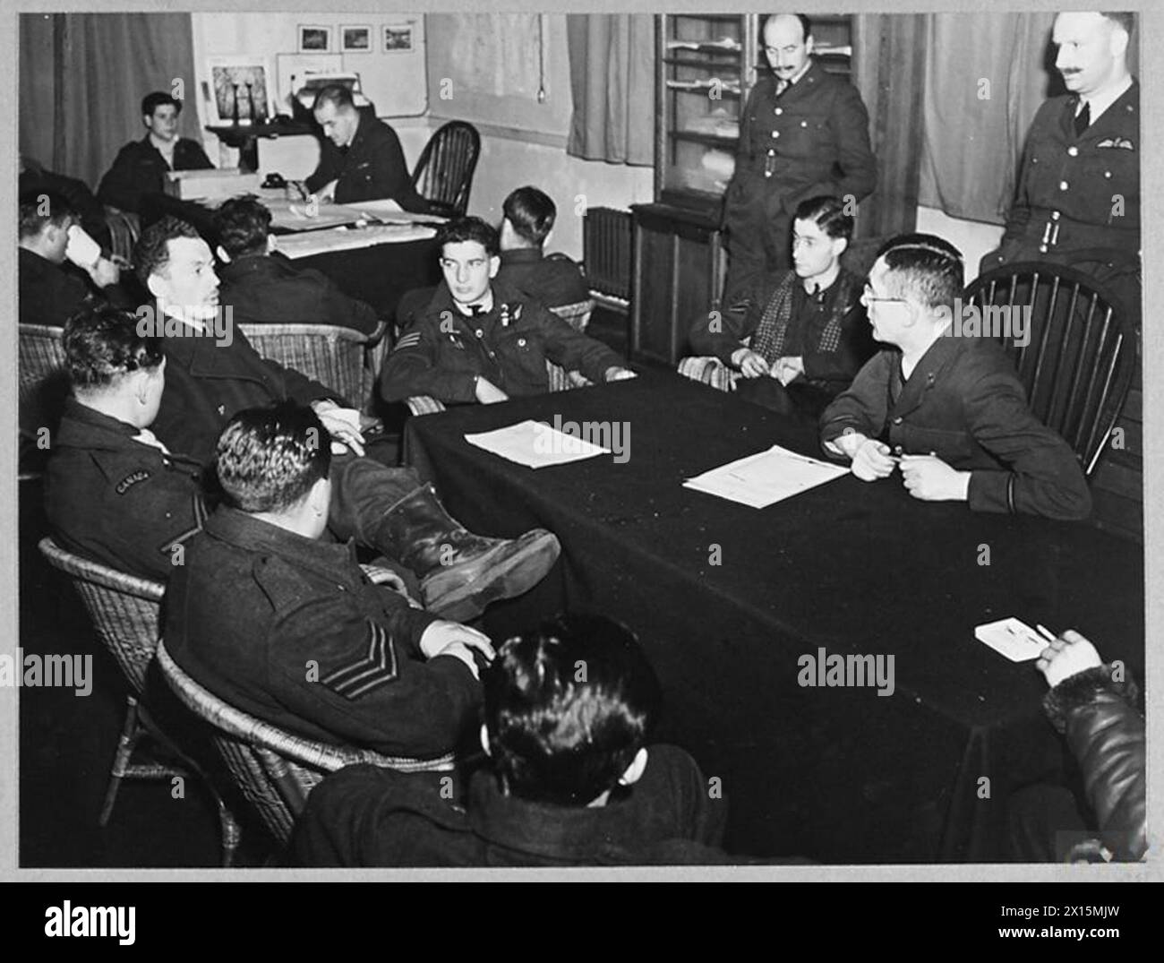 Photograph of Royal Air Force crew recounting a nighttime raid ...