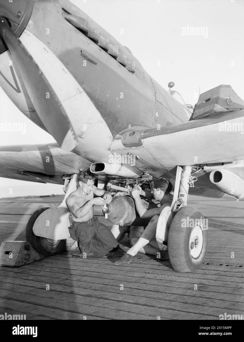 A Seafire III aircraft is being armed with a 500lb bomb on board HMS ...