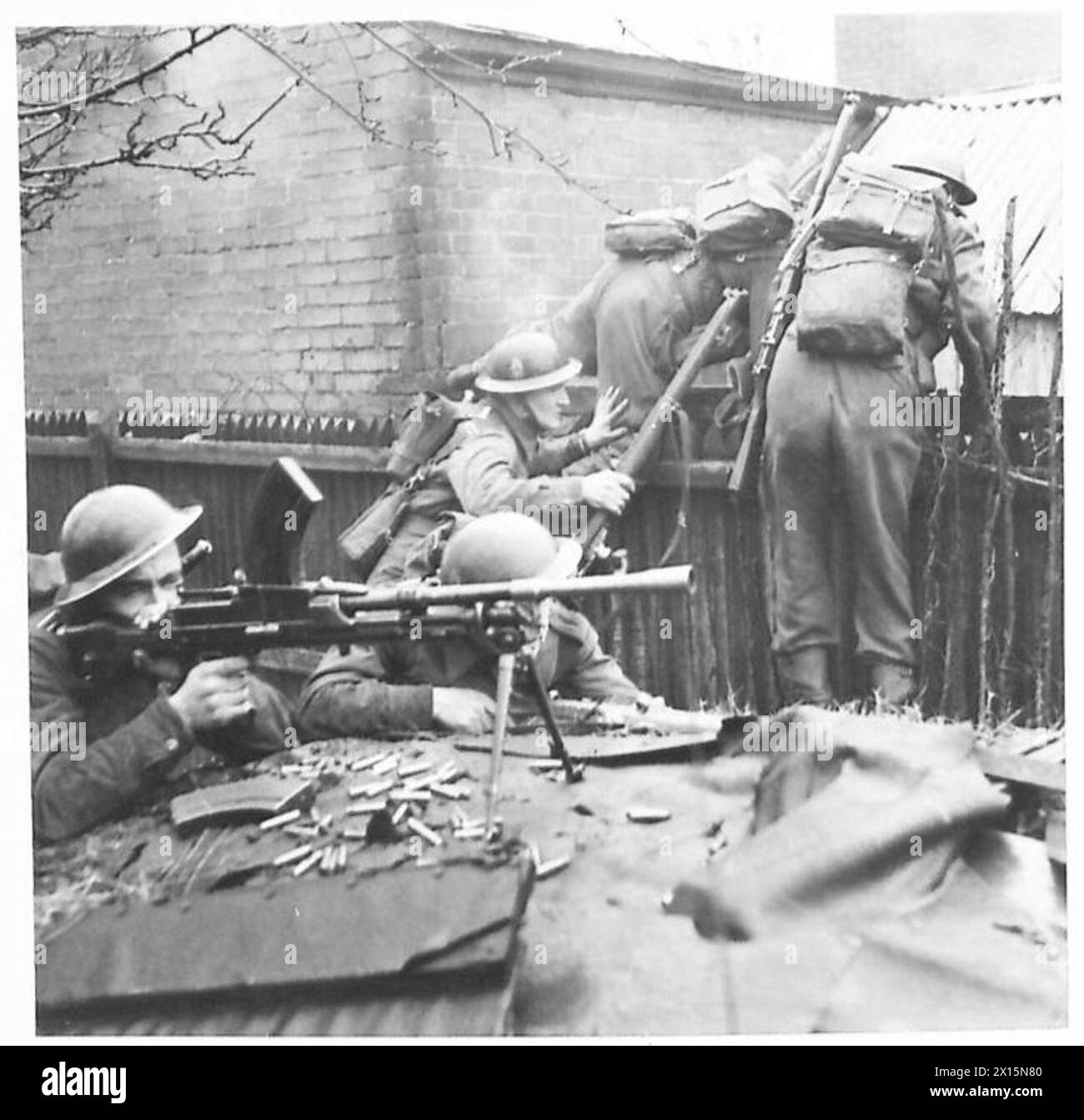 A British Army patrol advances over bombed streets and back gardens to ...