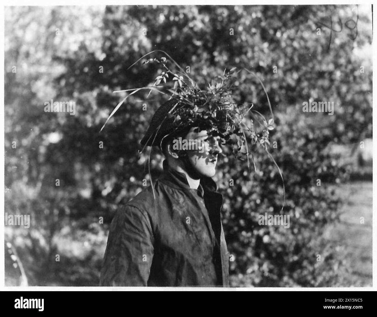 A British Army soldier uses natural elements to camouflage himself for ...