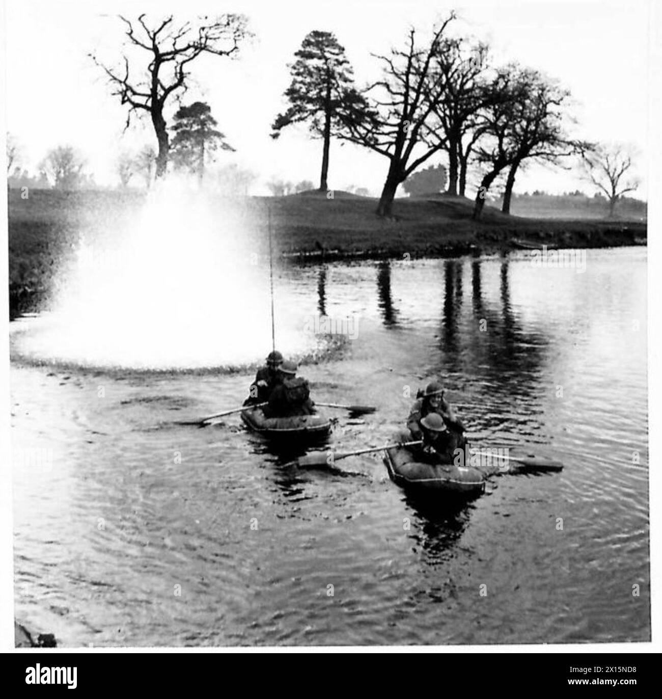 A reconnaissance soldier and wireless operator crossing a river in ...