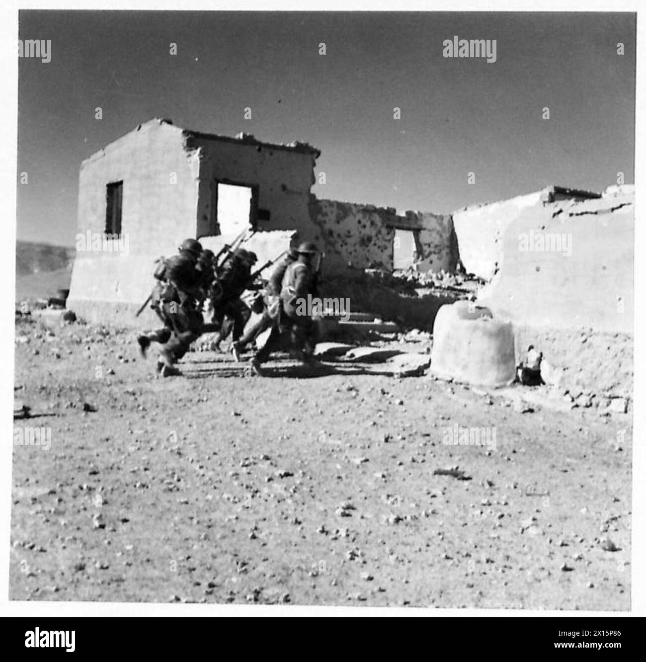 Officials Mr. Lyttelton and Mr. Bullitt inspect a captured enemy gun ...