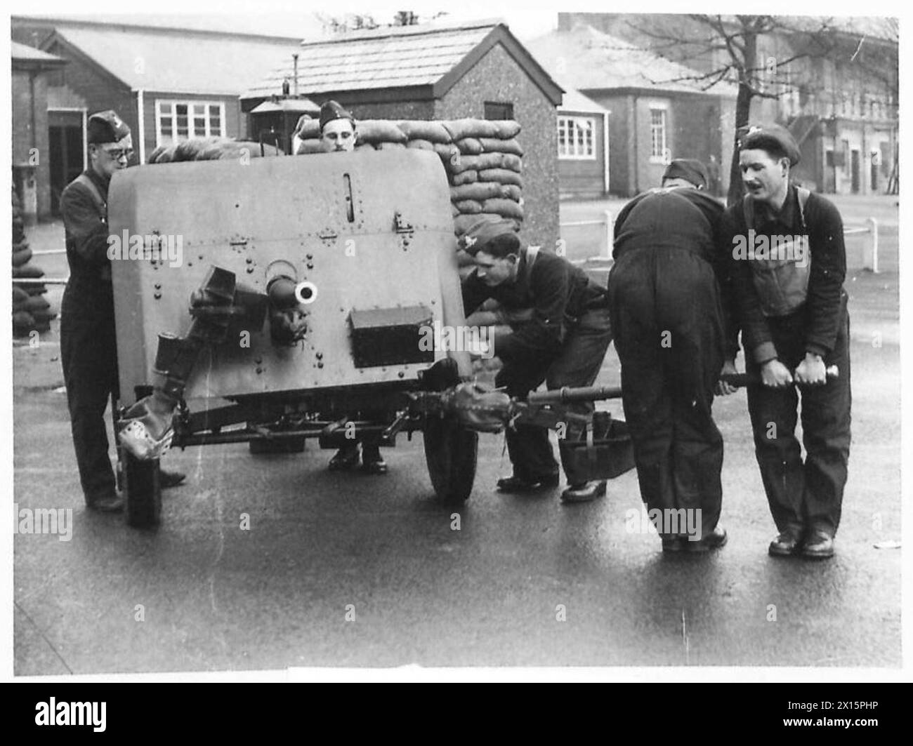 Anti-tank gunners are shown mounting their gun for action during ...