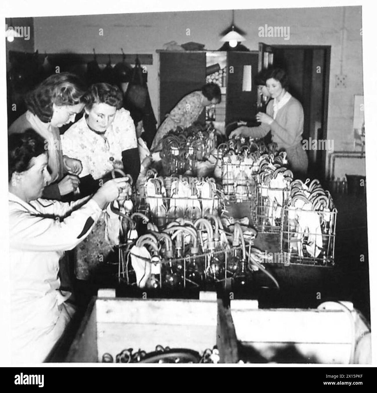 Voluntary workers assemble blood bottles for the Army Blood Transfusion ...