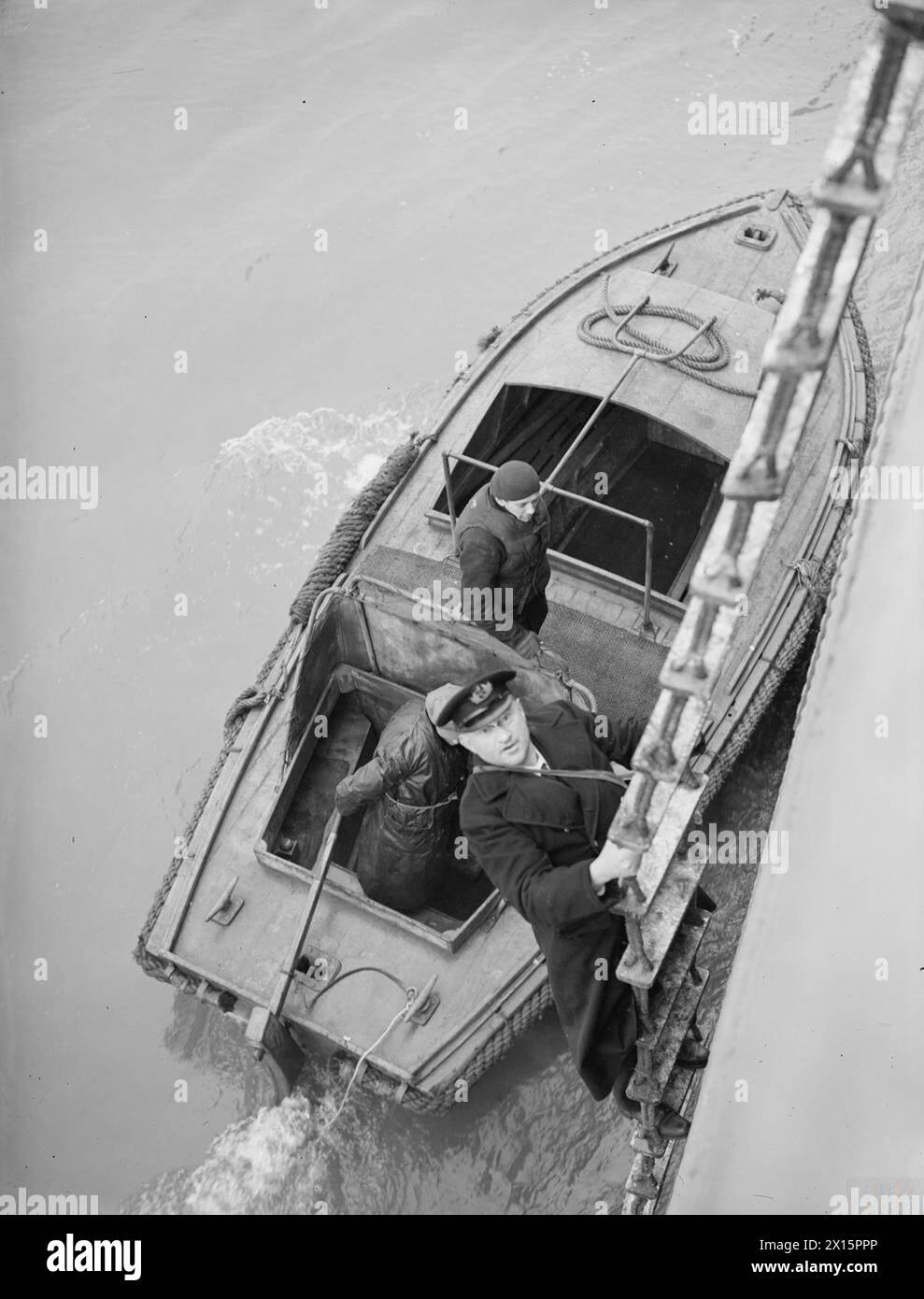 A pilot goes ashore from the British merchant ship Empire Kangaroo in ...