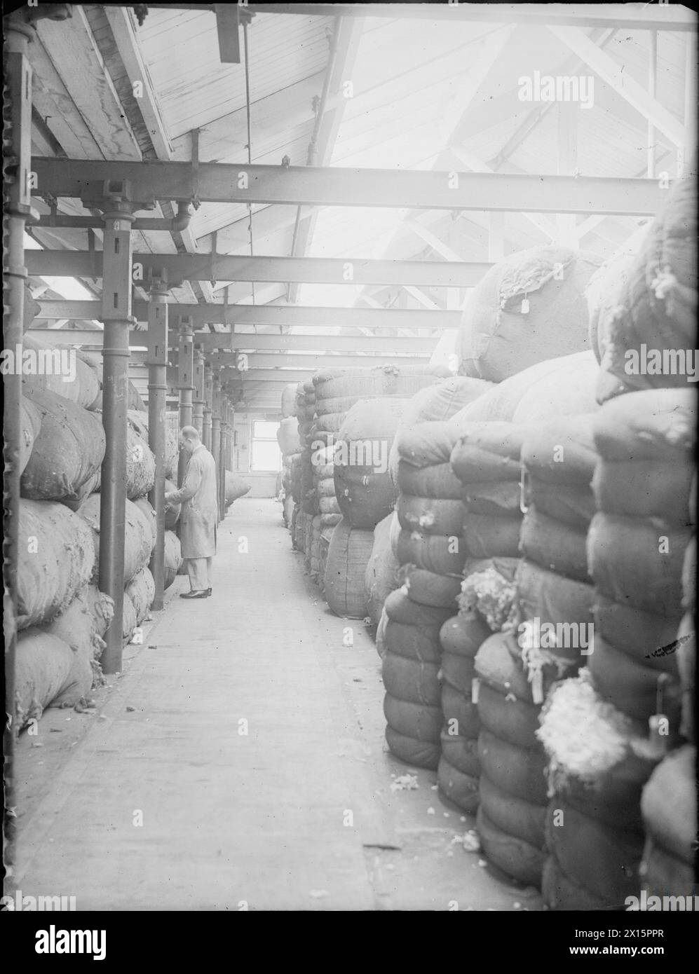 Large bales of wool are stored in the warehouse of C & J Hirst and Sons ...
