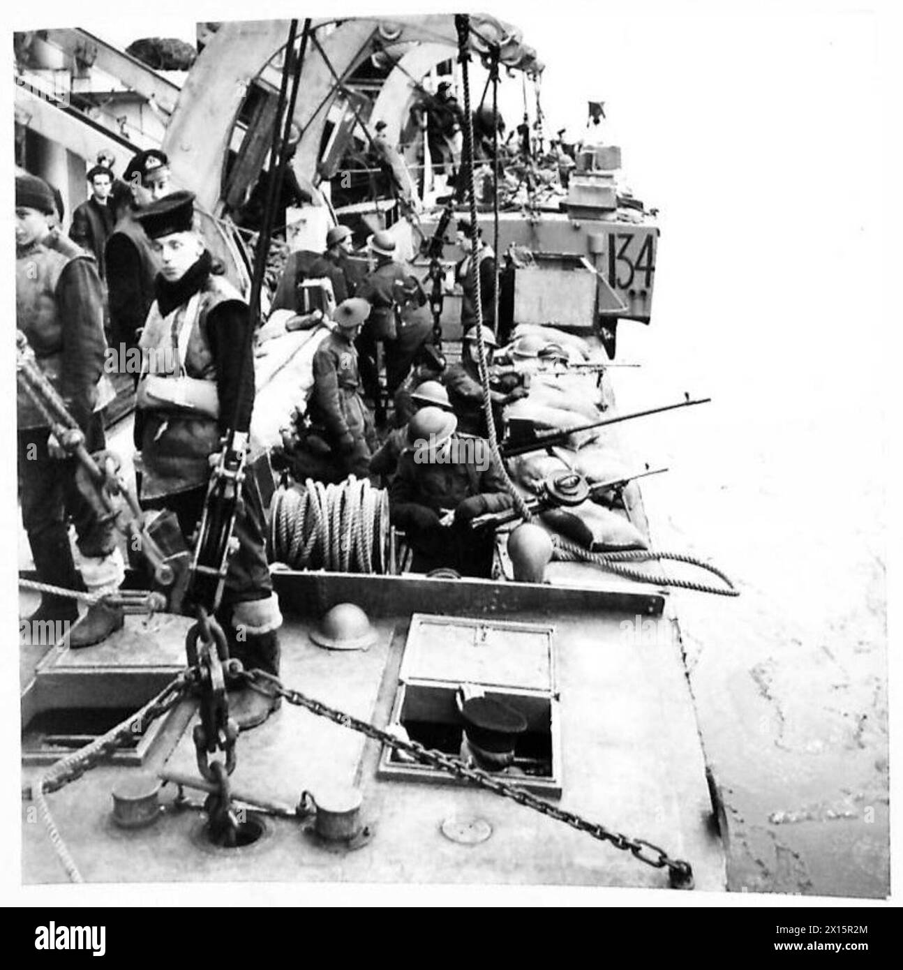British Army personnel lower a landing craft from a raiding ship during ...