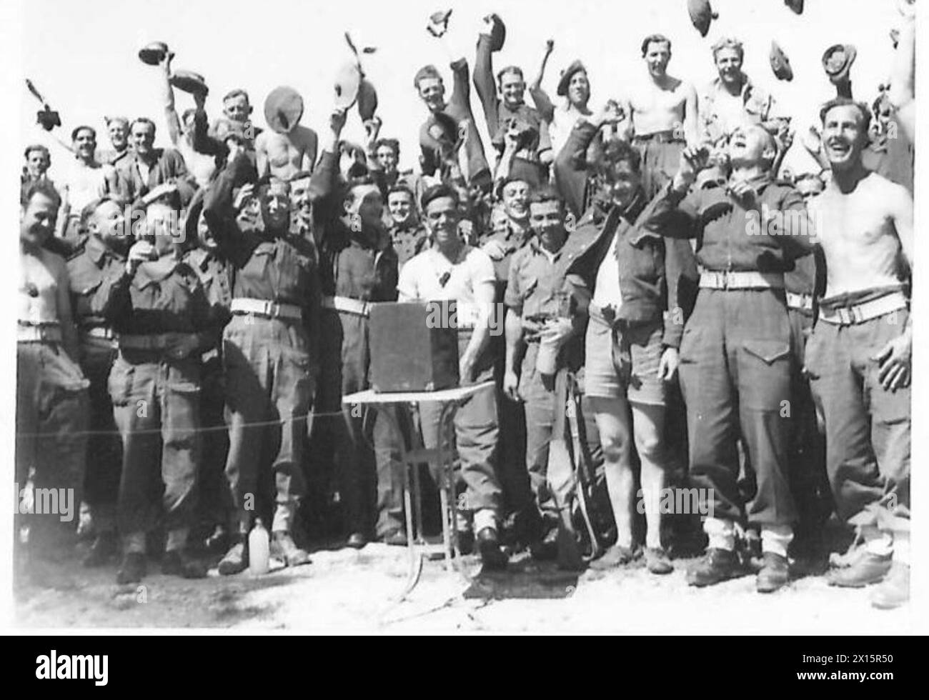EIGHTH ARMY : INFANTRYMEN CELEBRATE V.E. DAY - Caps are thrown into the ...