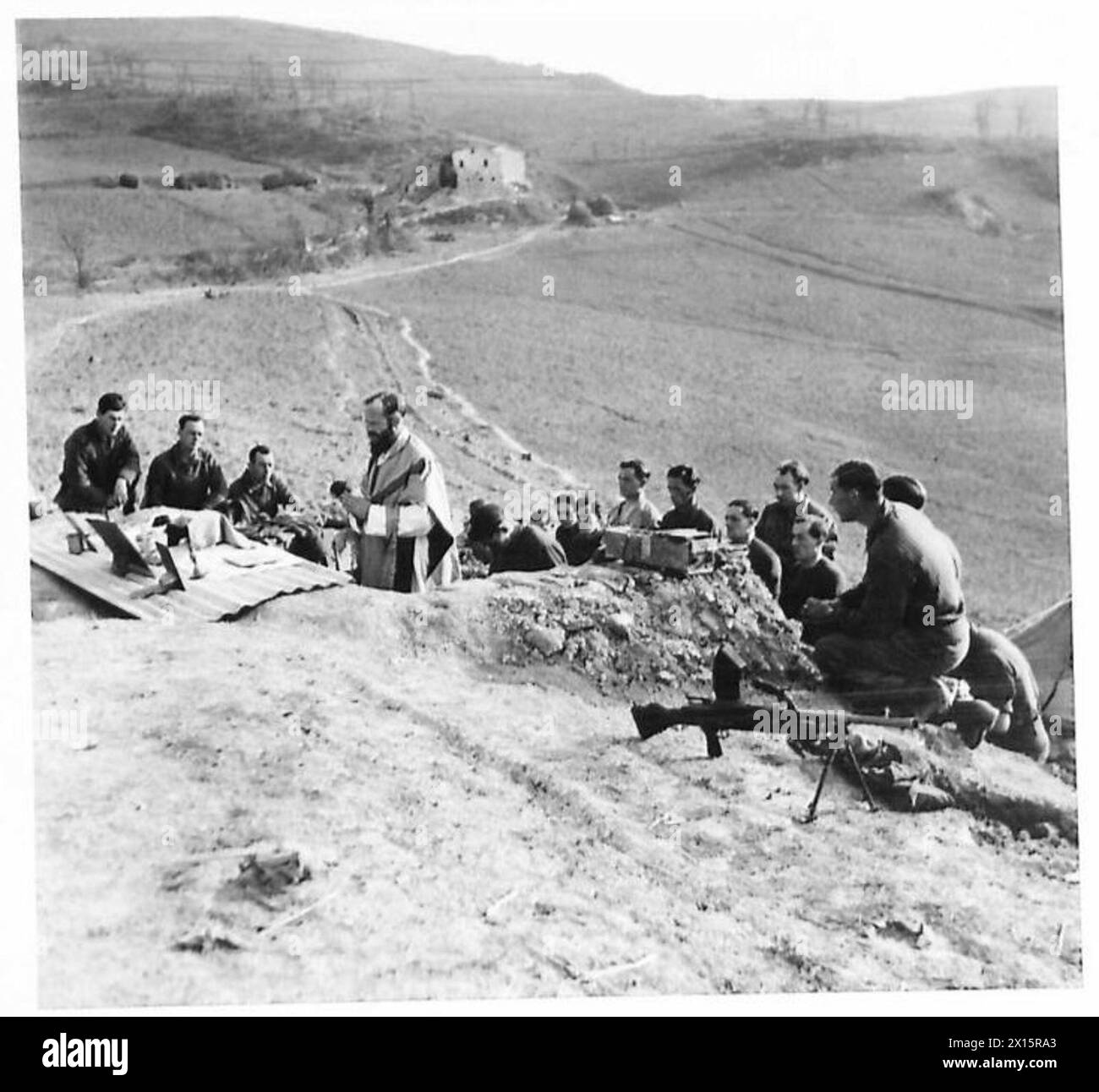 Father Flynn conducts a Roman Catholic service in forward hilltop ...
