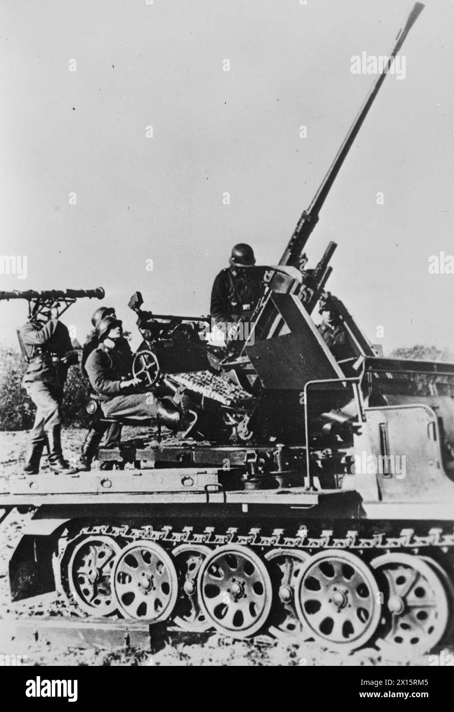 Photograph showing German military vehicles including a 3.7cm Flak36 ...