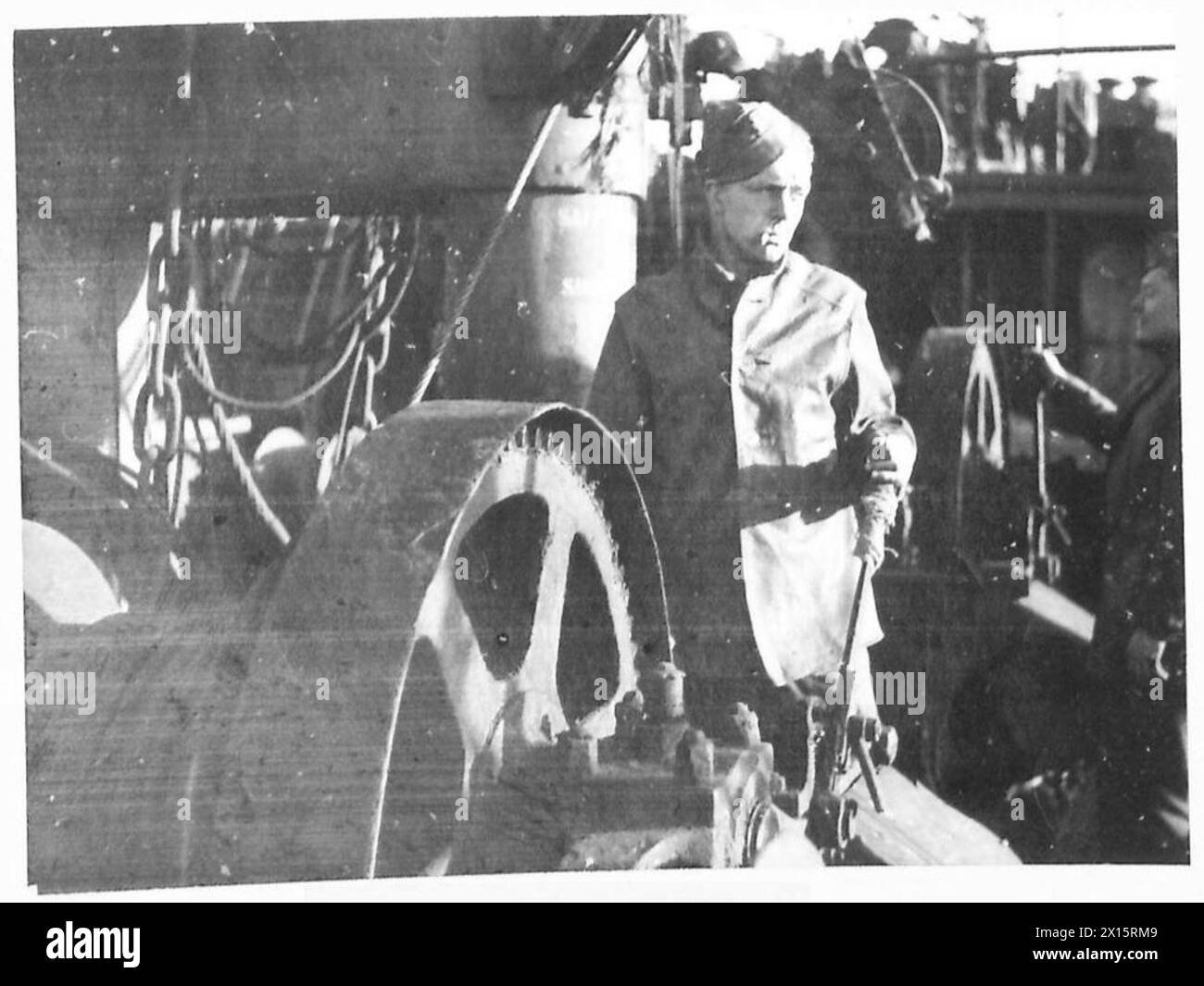 An A.M.P.C. winch operator unloads stores for British and Canadian ...