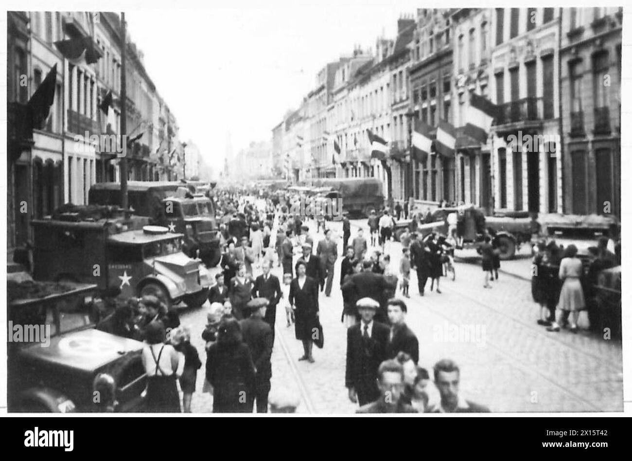Groups of civilians speak with British troops along Main Street in ...