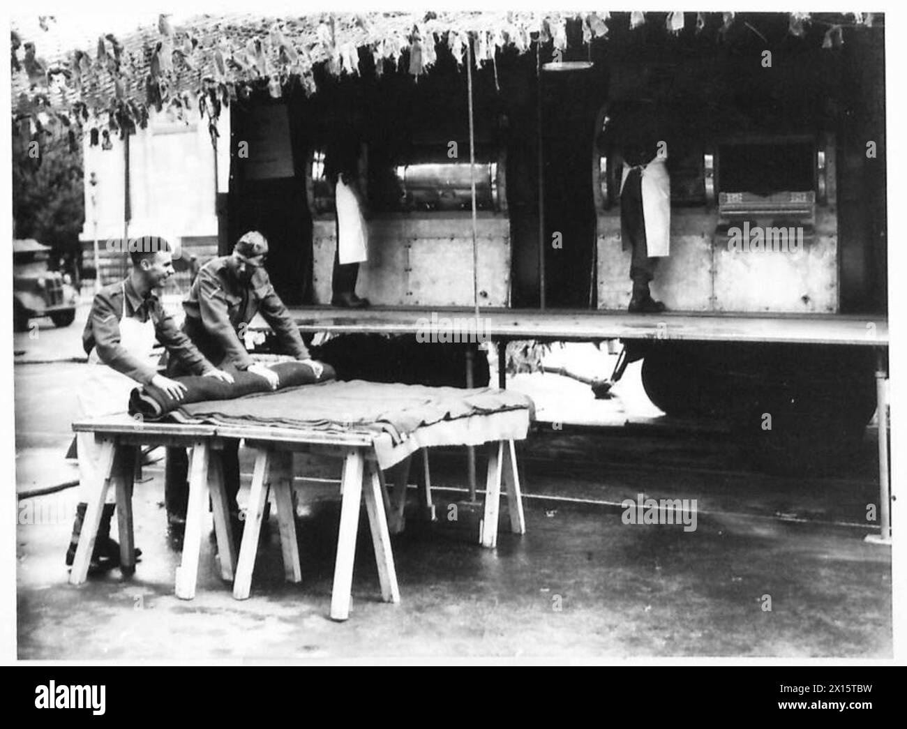MOBILE LAUNDRY UNIT - Rolling up the clean blankets British Army Stock ...