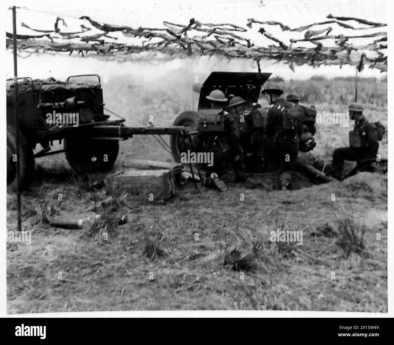 A gun is captured in the act of being fired, showing the firing ...
