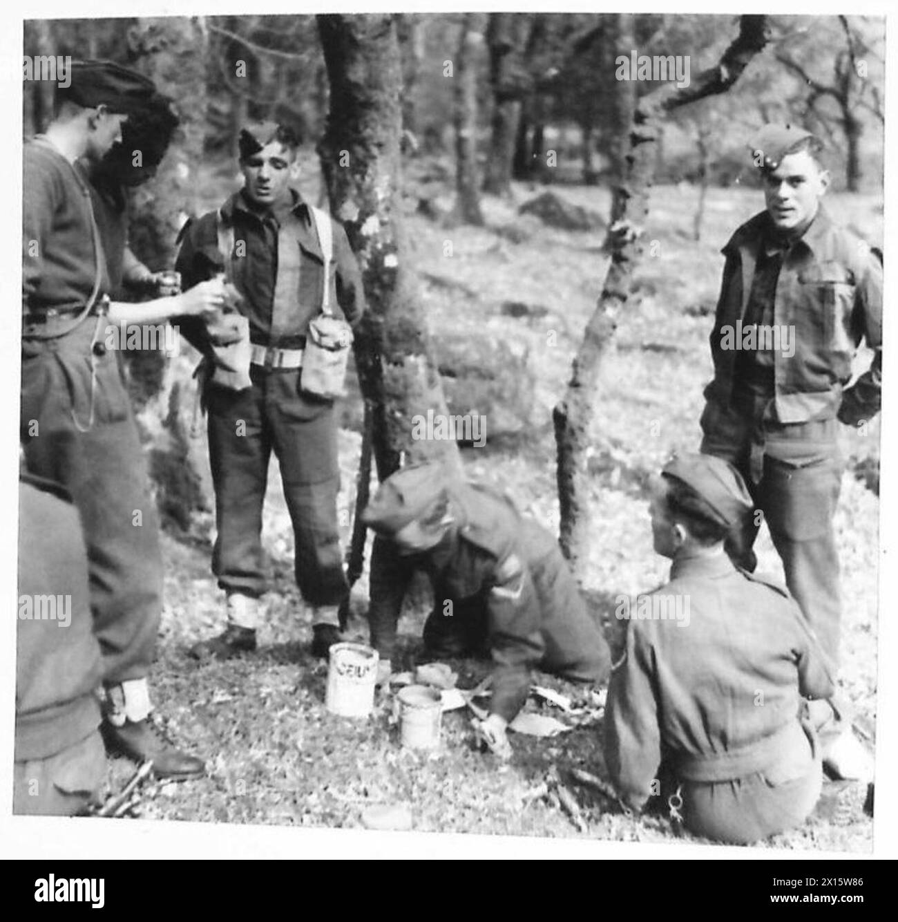 Men in the British Army experiment with camouflaged equipment while ...