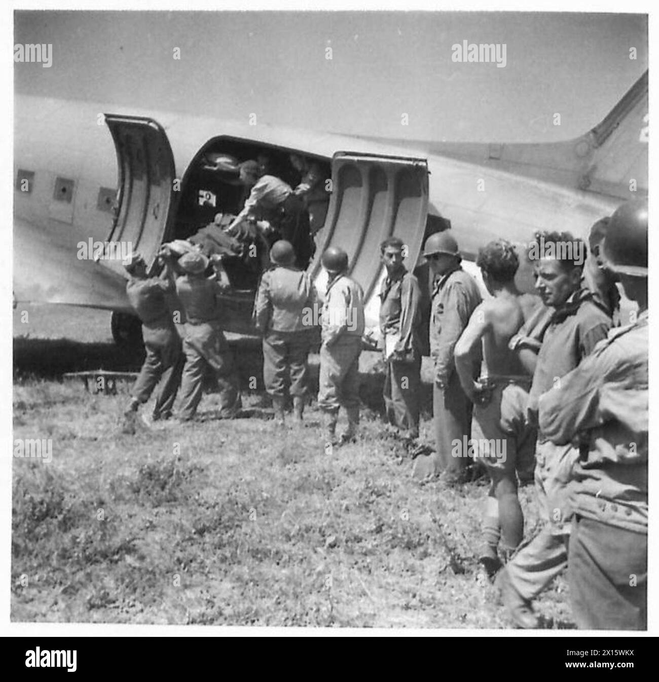 A wounded soldier was lifted on a stretcher into a Douglas aircraft for ...