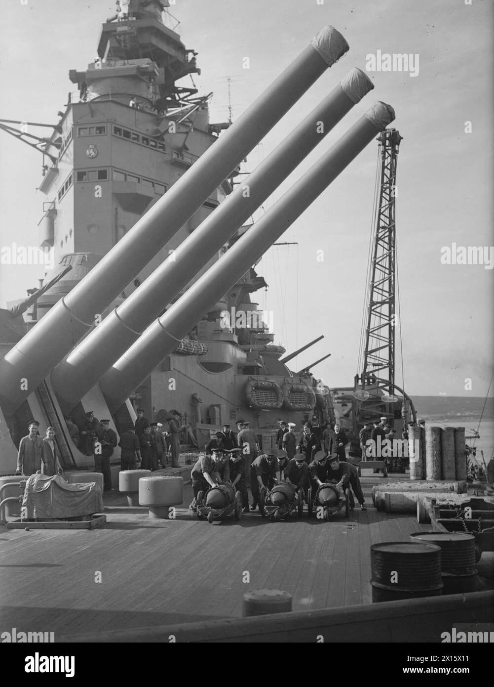 In July 1941 aboard battleship HMS Nelson, crew are striking 16-inch ...