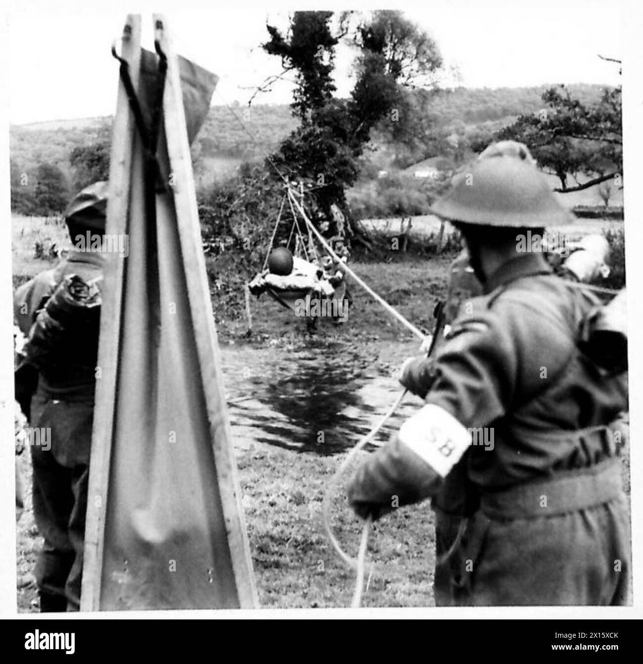 HOME GUARD MEDICAL EXERCISE - A stretcher attached to a rope cable is ...
