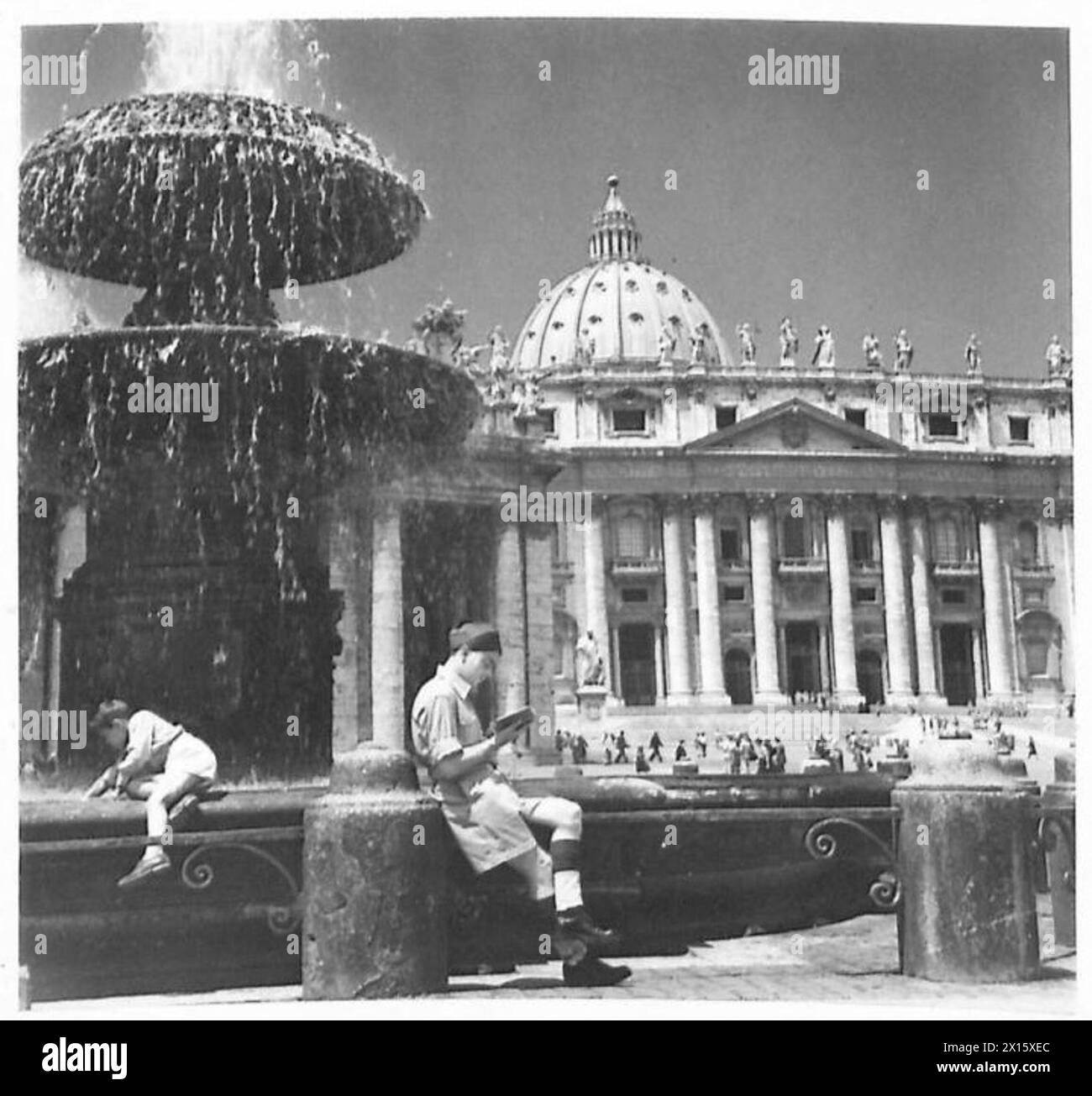 Gunner Smith rests beside a fountain in St. Peter's Square, Rome, consulting his guide book ...
