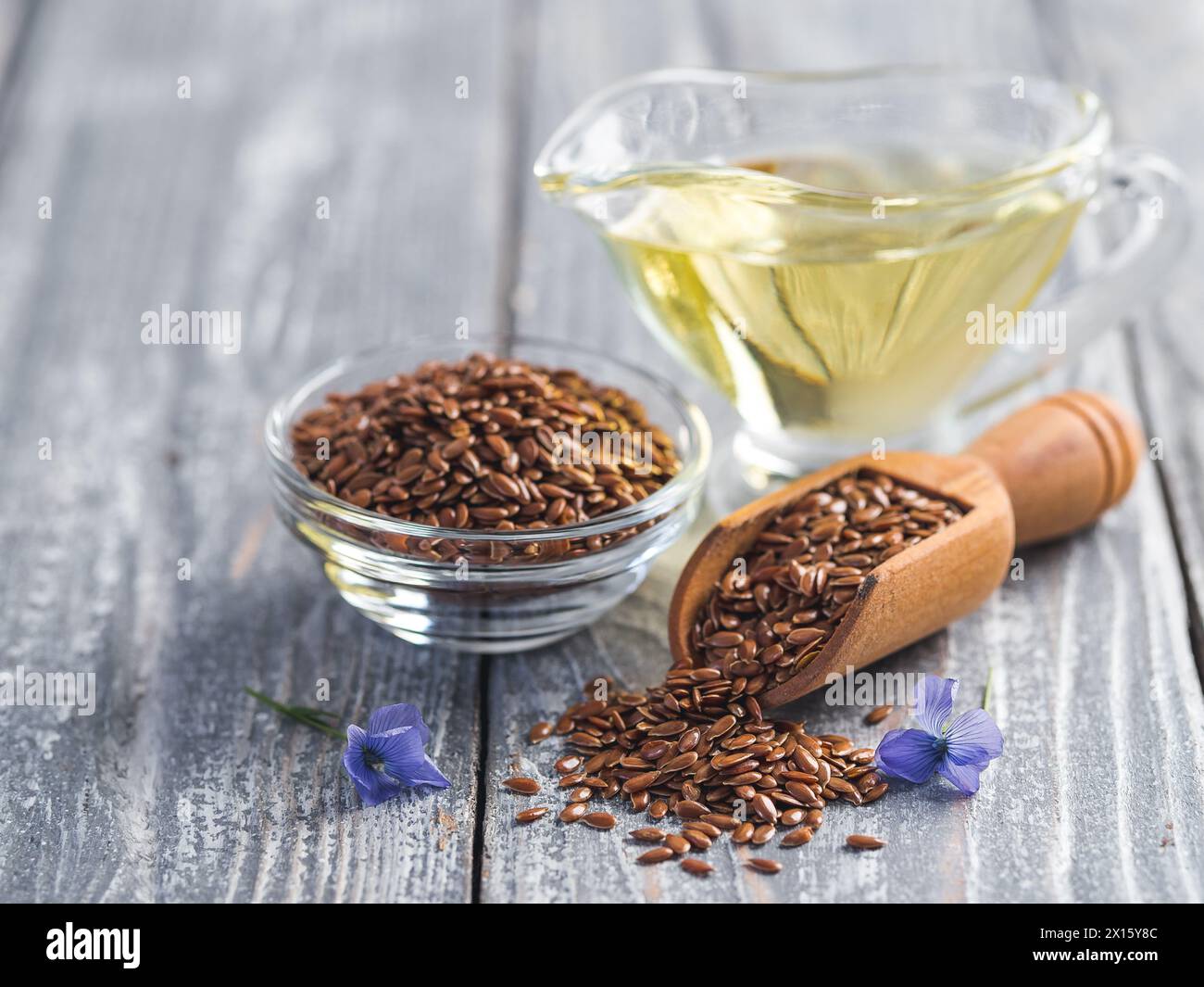 Flax seeds and flax oil. Brown linen seeds, flaxseed oil and blue flax ...