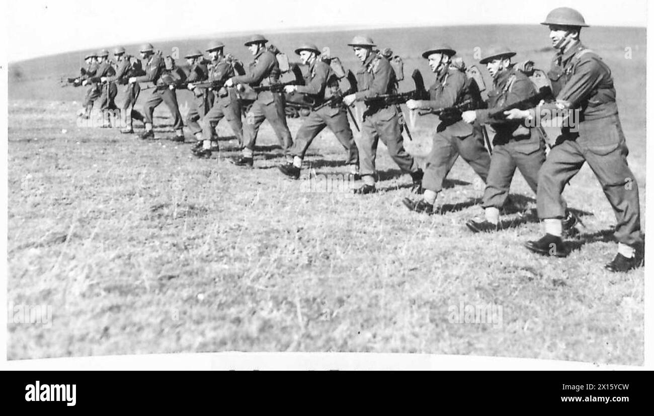 FIRING FROM THE HIP - Some of the men advancing in line with their Bren ...