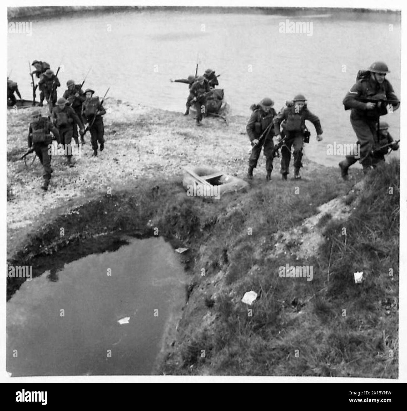 Troops press forward to attack after crossing a river in collapsible boats during an infantry ...