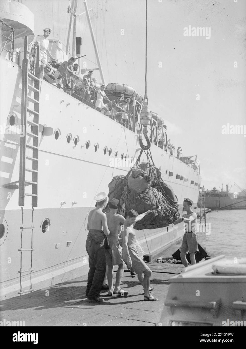 HMS CUMBERLAND DELIVERS THE MAIL. 26 OCTOBER 1945, COLOMBO, CEYLON. THE ...