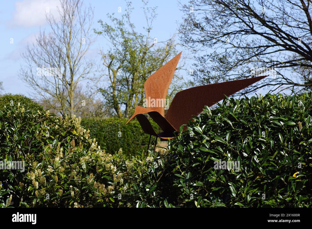 Sculpture of a bird made made from rust-coloured corten steel by Baab ...