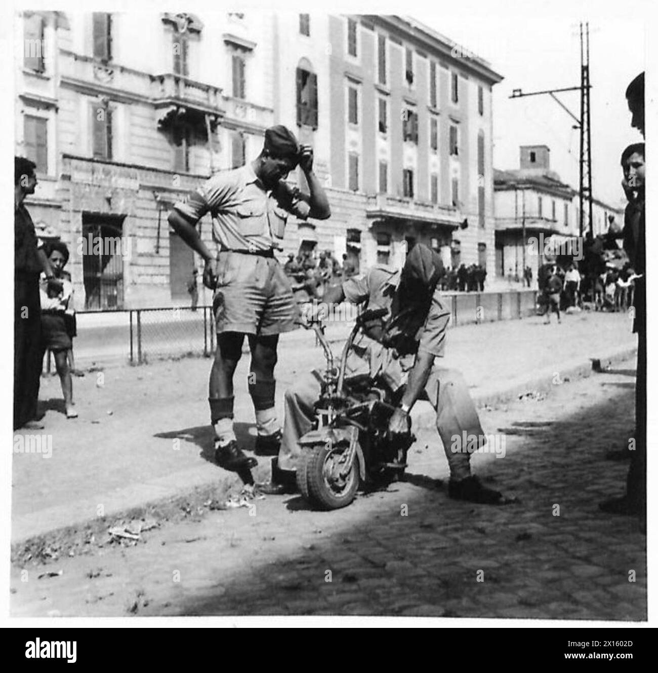 British soldiers use a captured German paratrooper's motorcycle for ...