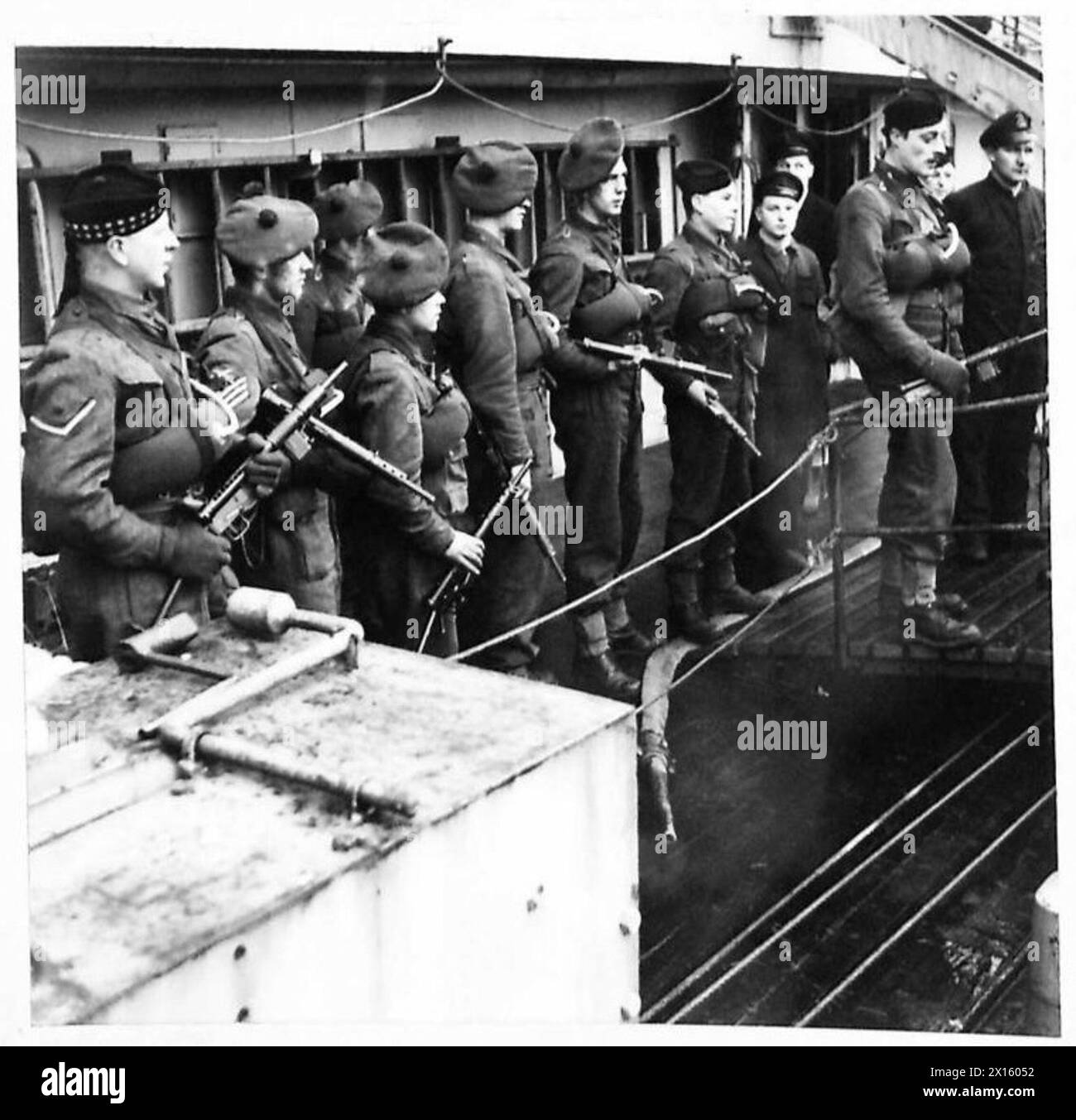 Troops wear life jackets and await entry into a landing craft during ...