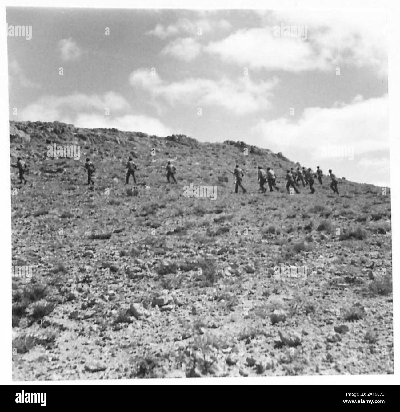 A section of British Army soldiers advances up a hillside during ...