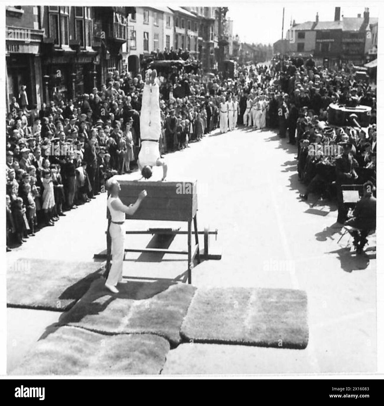 MILITARY DISPLAY FOR WORKERS - Crowds watch the physical training team ...