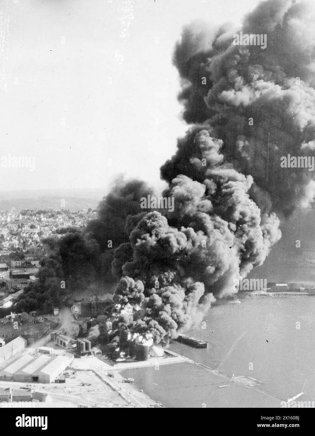 Official photograph - Smoke and flame from oil tanks in St. Malo ...