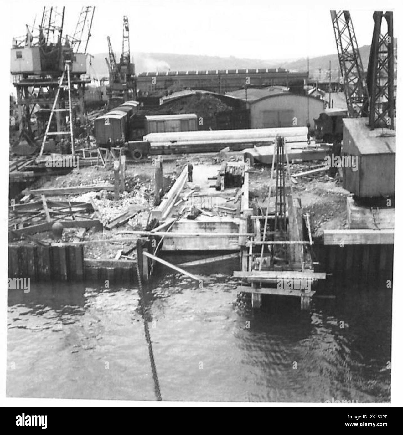 PROGRESS WORK ON LARNE JETTY - Close view of tamp , British Army Stock ...