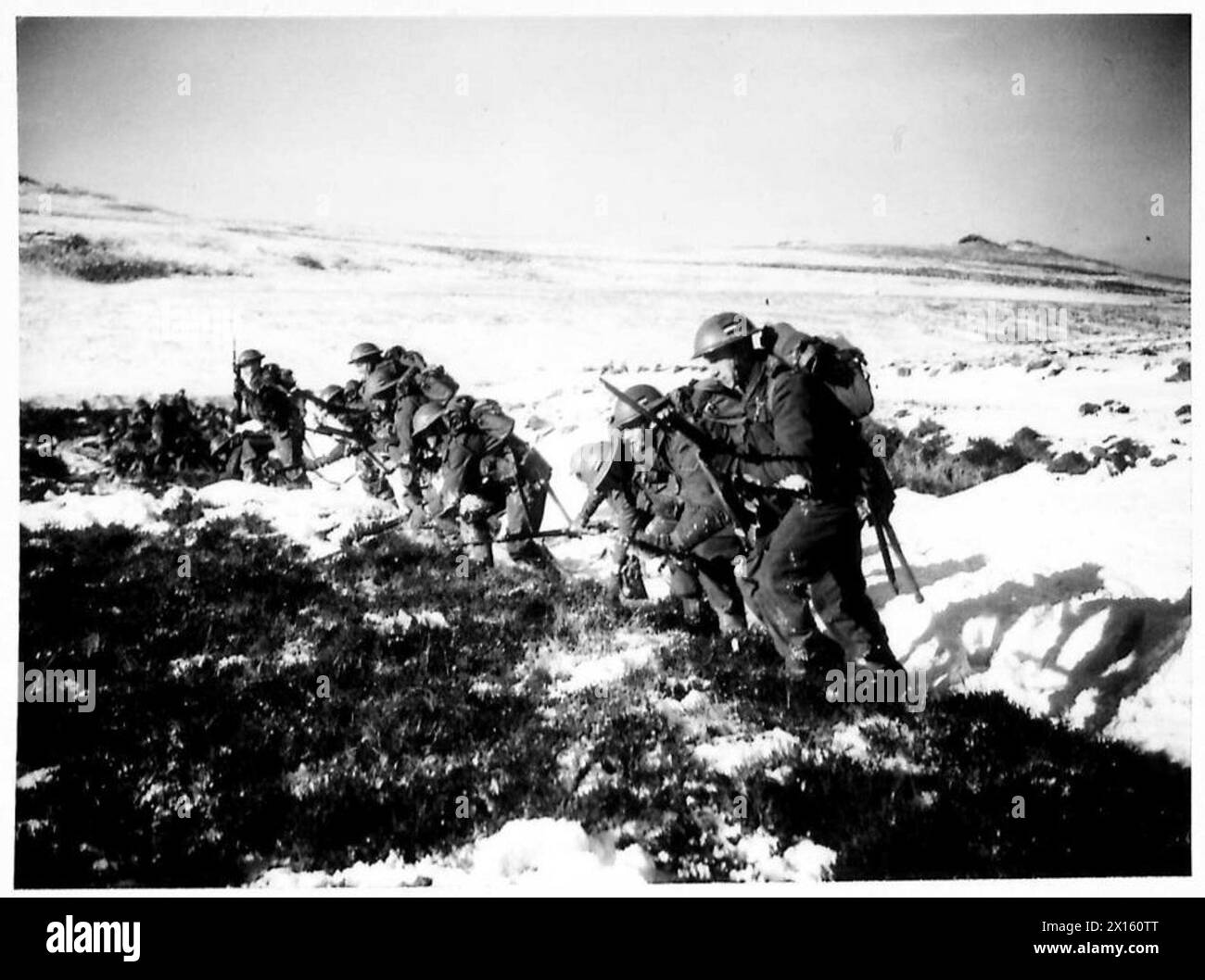 BRITAIN'S ARMY TRAINS UNDER ACTUAL SHELL FIRE - Troops advancing behind ...