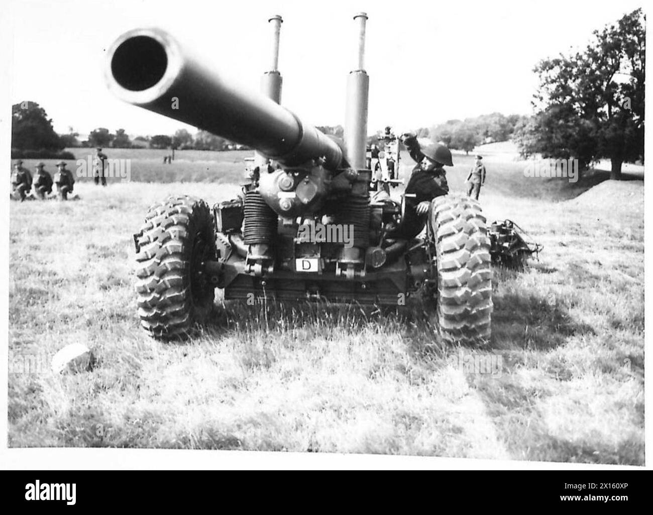 A gun layer adjusts the sights on a howitzer while the artillery piece ...