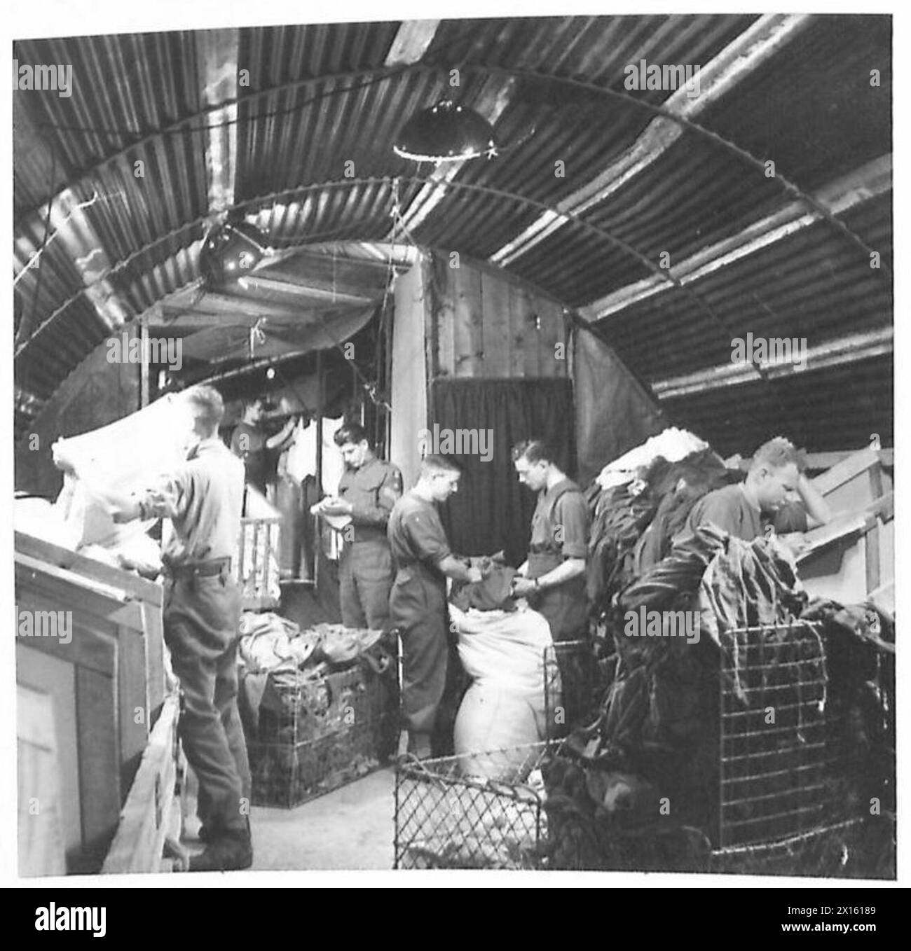 Personnel sort and organize thousands of laundered shirts with high ...