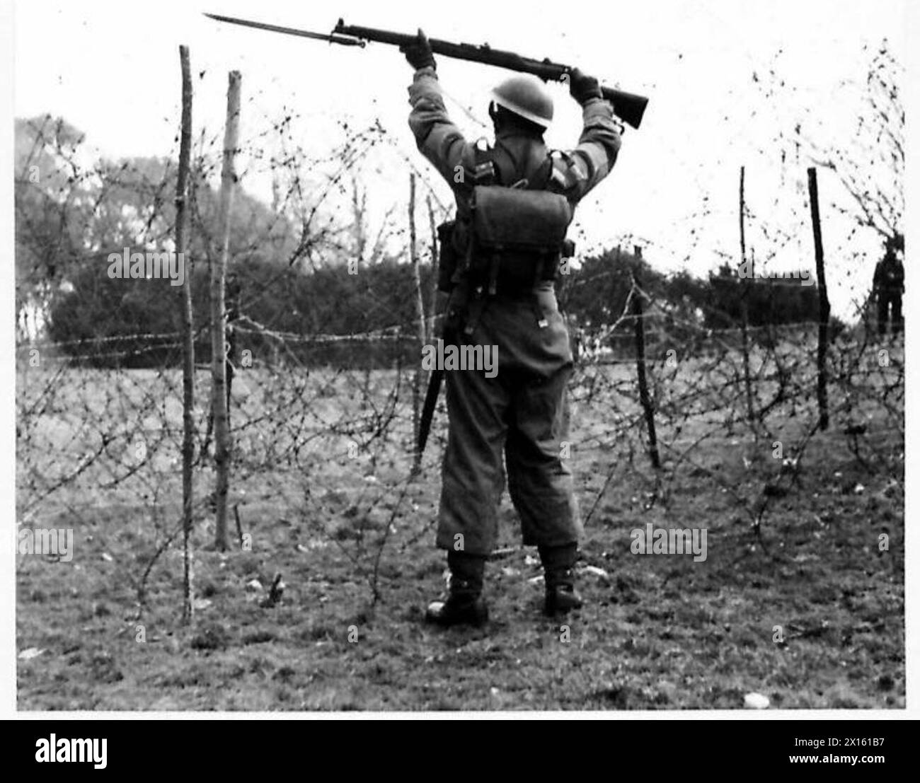 A NEW METHOD OF TACKLING BARBED WIRE OBSTRUCTIONS - This soldier shows ...