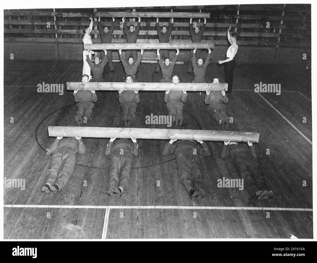 TRAINING P.T. INSTRUCTORS - A class undergoing exercises with a heavy ...