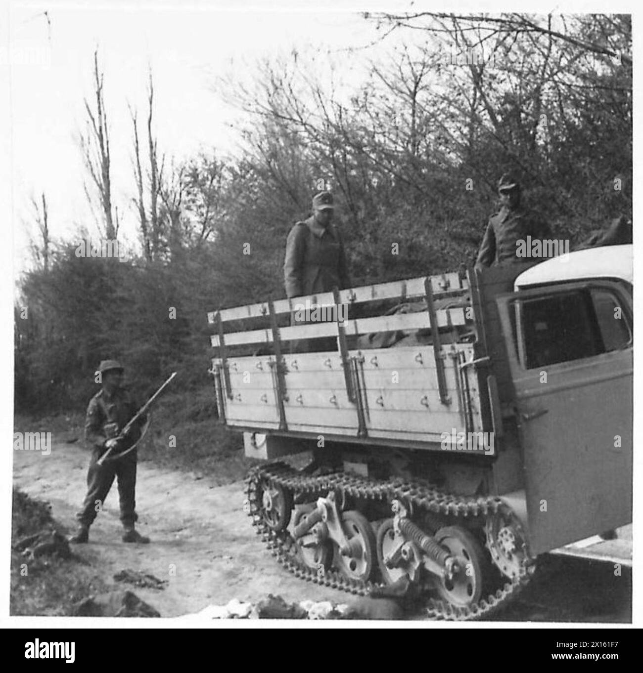 Two German soldiers are captured hiding in a truck during a joint ...