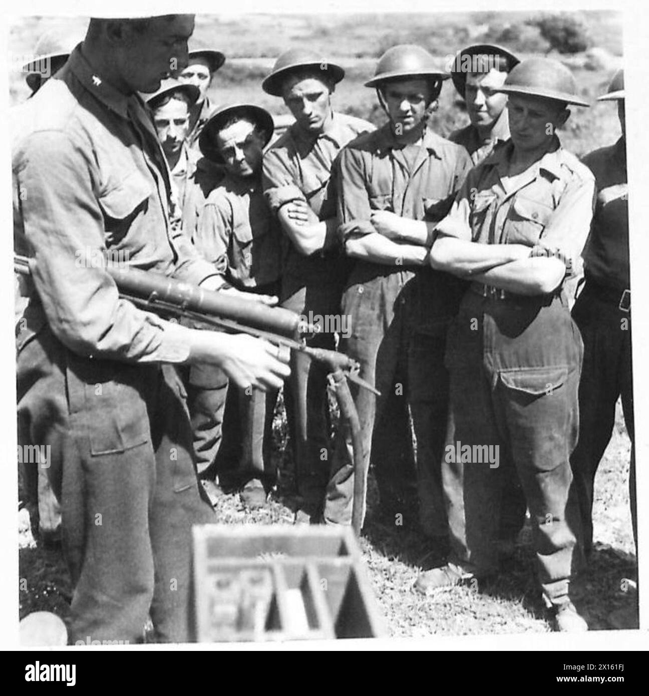 Lieutenant Popplewell positions the cylinder on an American portable flame-thrower, showing use ...