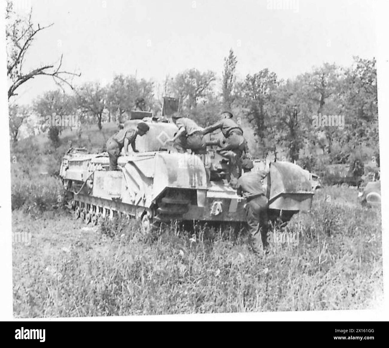 The crew of a Churchill tank board their vehicle and move to action ...