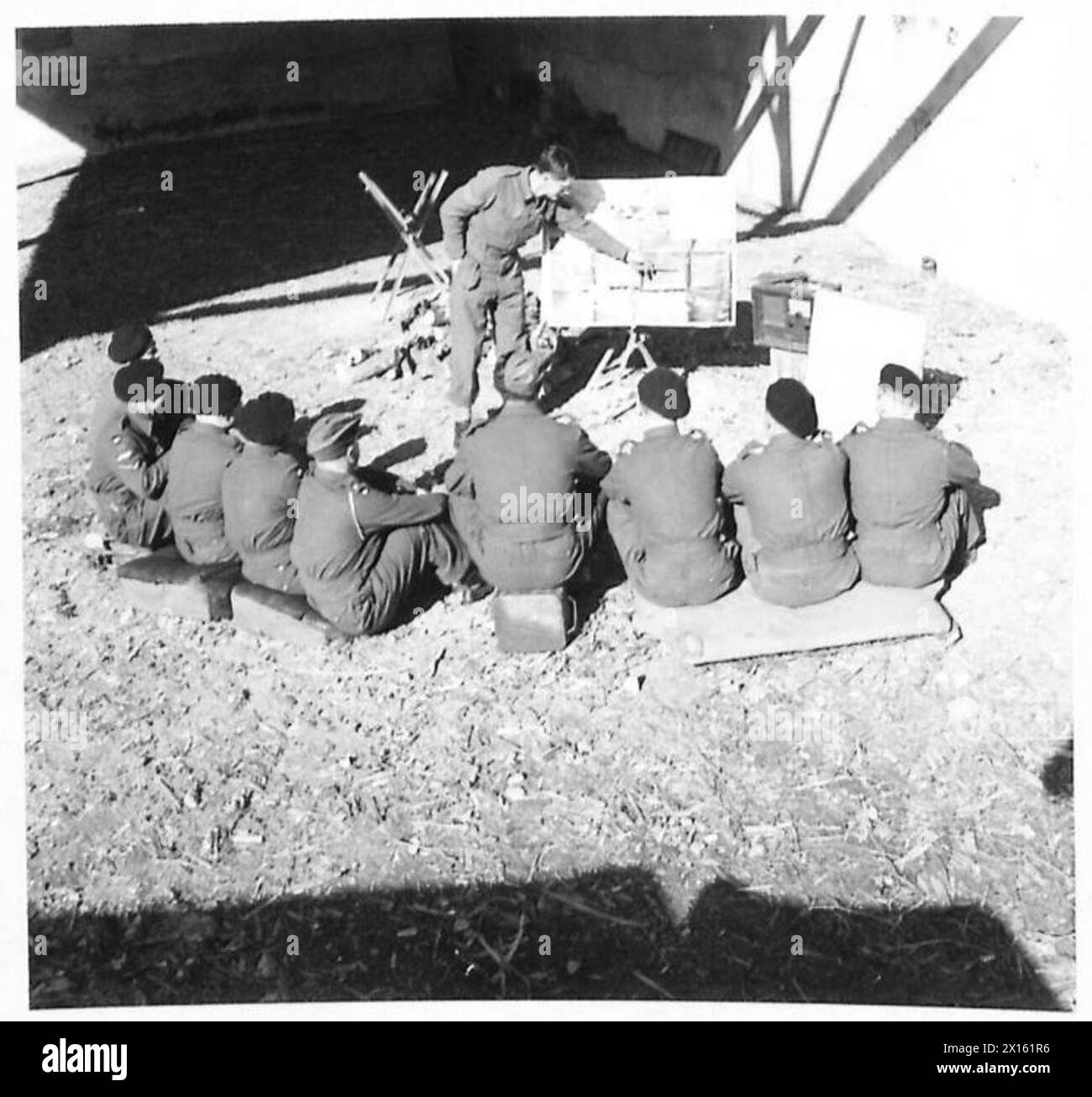 Sergeant E.G. Barker delivers a briefing on current news and war fronts ...
