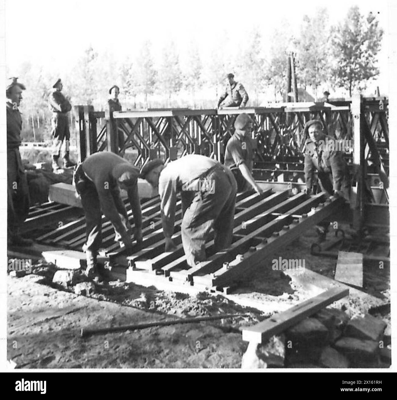 Soldiers of the 49th Division, 1st Corps, B.L.A., position bridge ramps ...