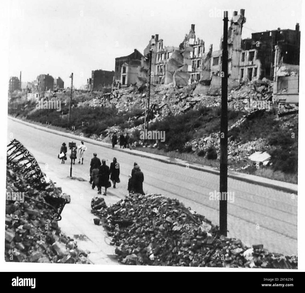 HAMBURG - German civilians trudge past their devastated city British ...