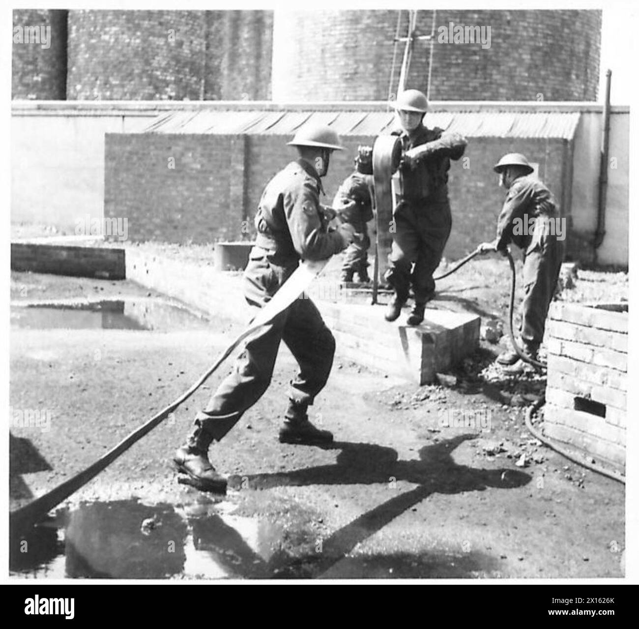 ARMY FIREMEN - The foam pipe is now attached and one of the men picks ...