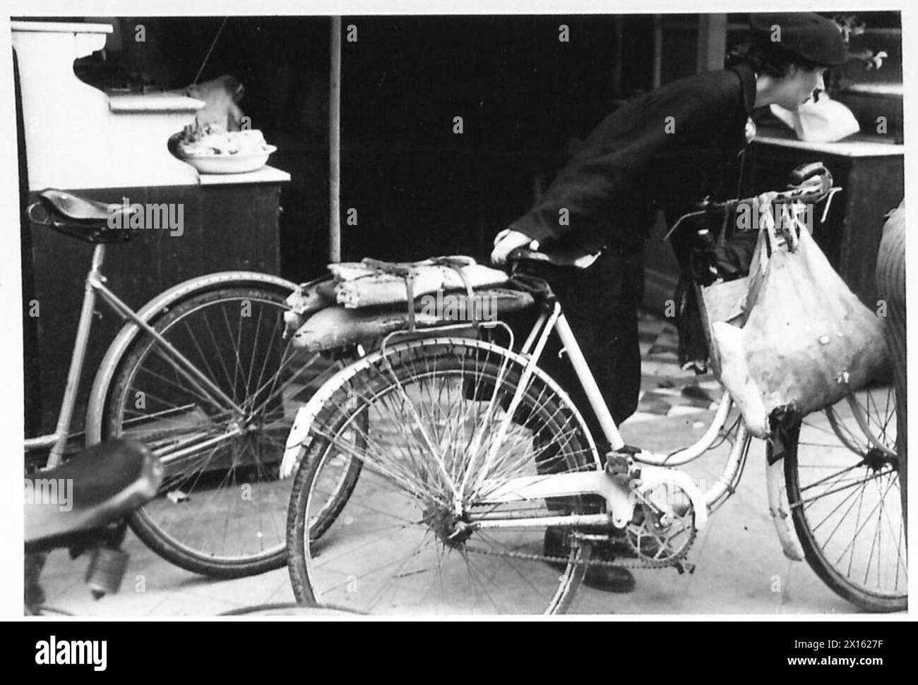 PRINTING FREE NEWSPAPER - The bread ration being collected; bread is ...