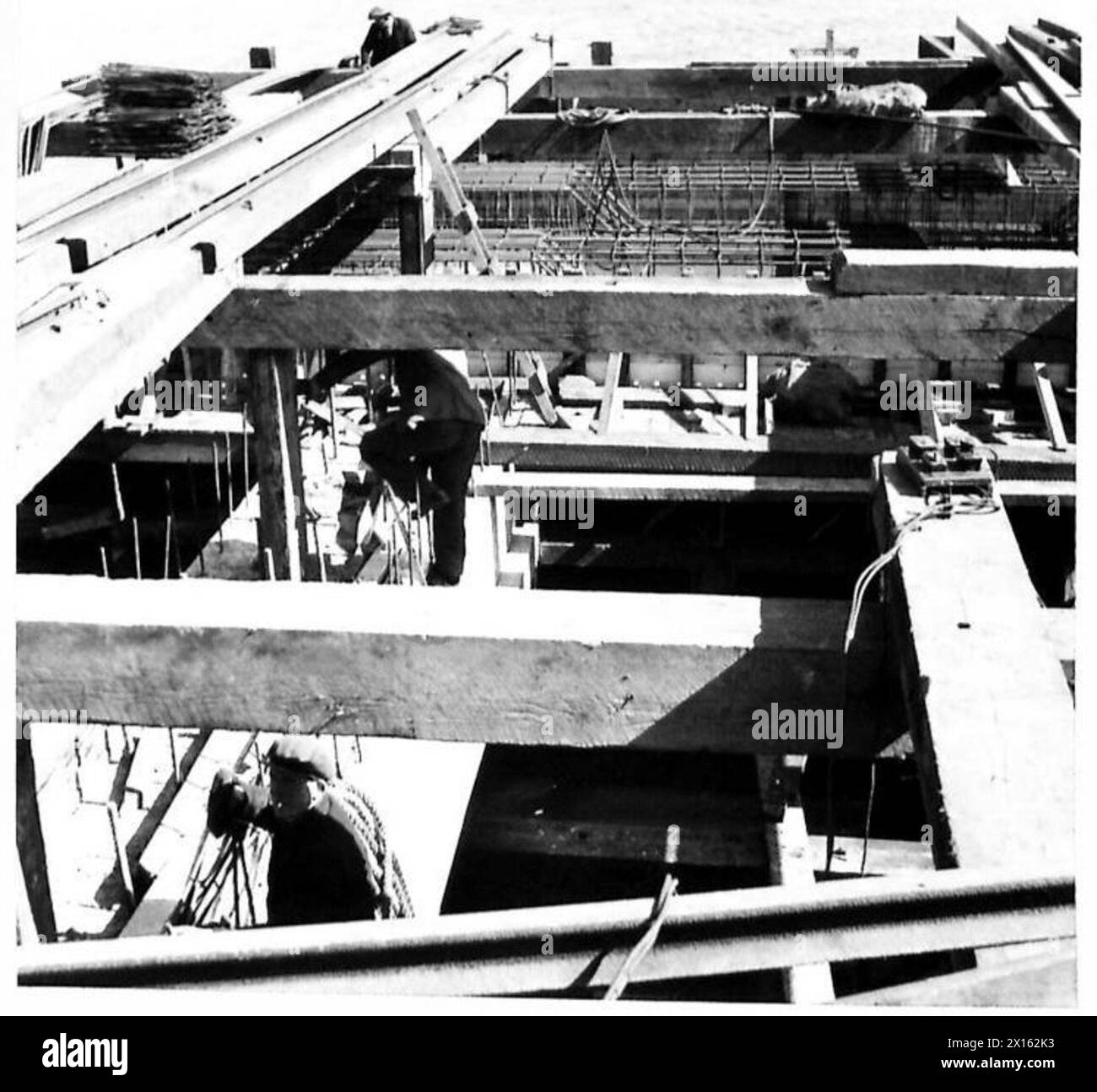 Pile caps and deck formwork are installed during construction of the ...